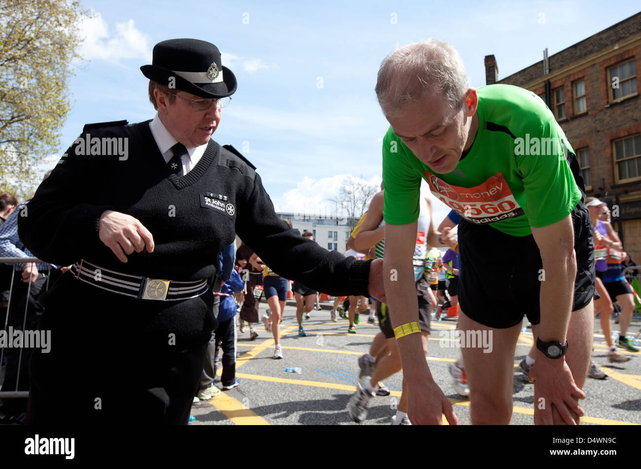 an exhausted runner looked after by st. john ambulance worker , the ...