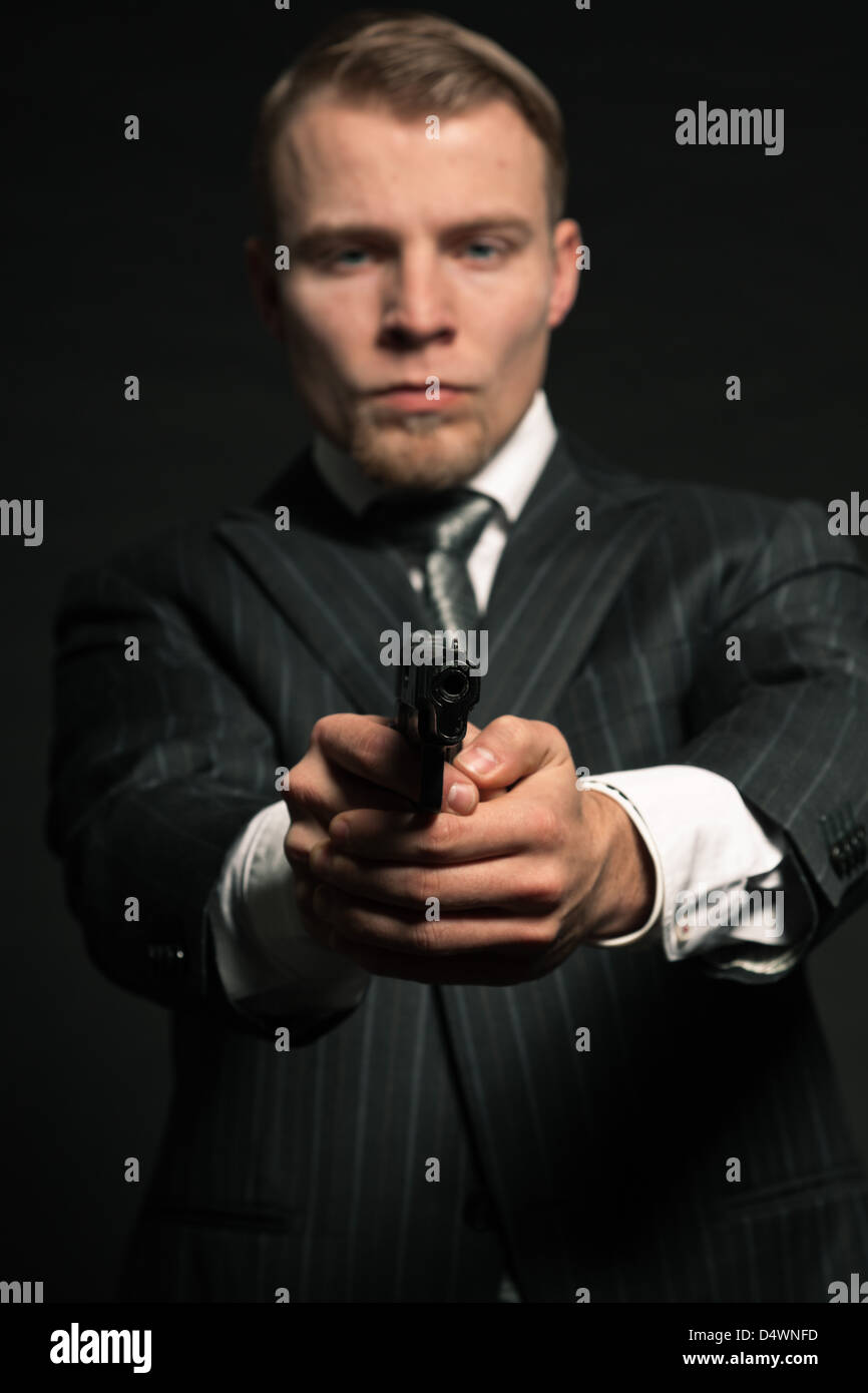 Man gun suit hi-res stock photography and images - Alamy