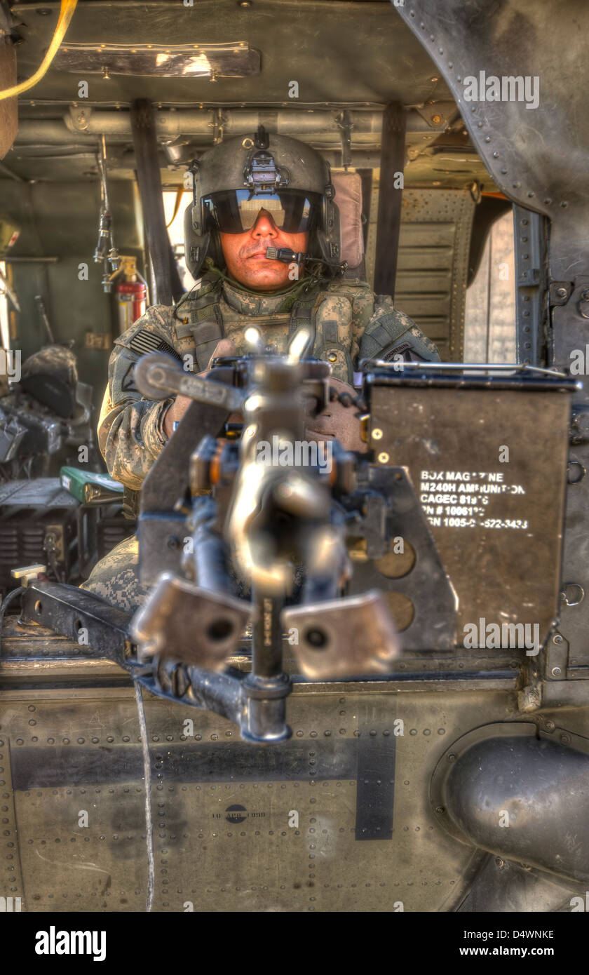 A UH-60 Black Hawk door gunner manning a M240B machine gun, Tikrit ...
