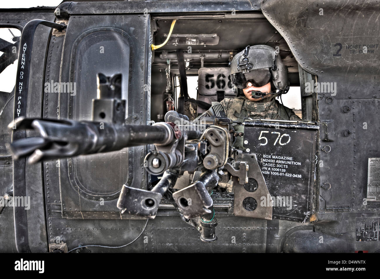 High dynamic range image of a UH-60 Black Hawk door gunner manning a ...