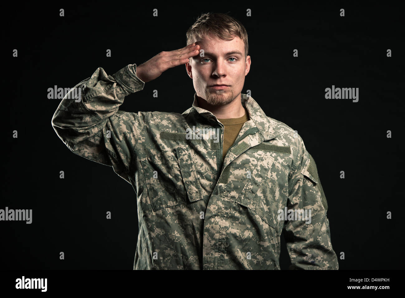Military young man salutes. Studio portrait Stock Photo - Alamy