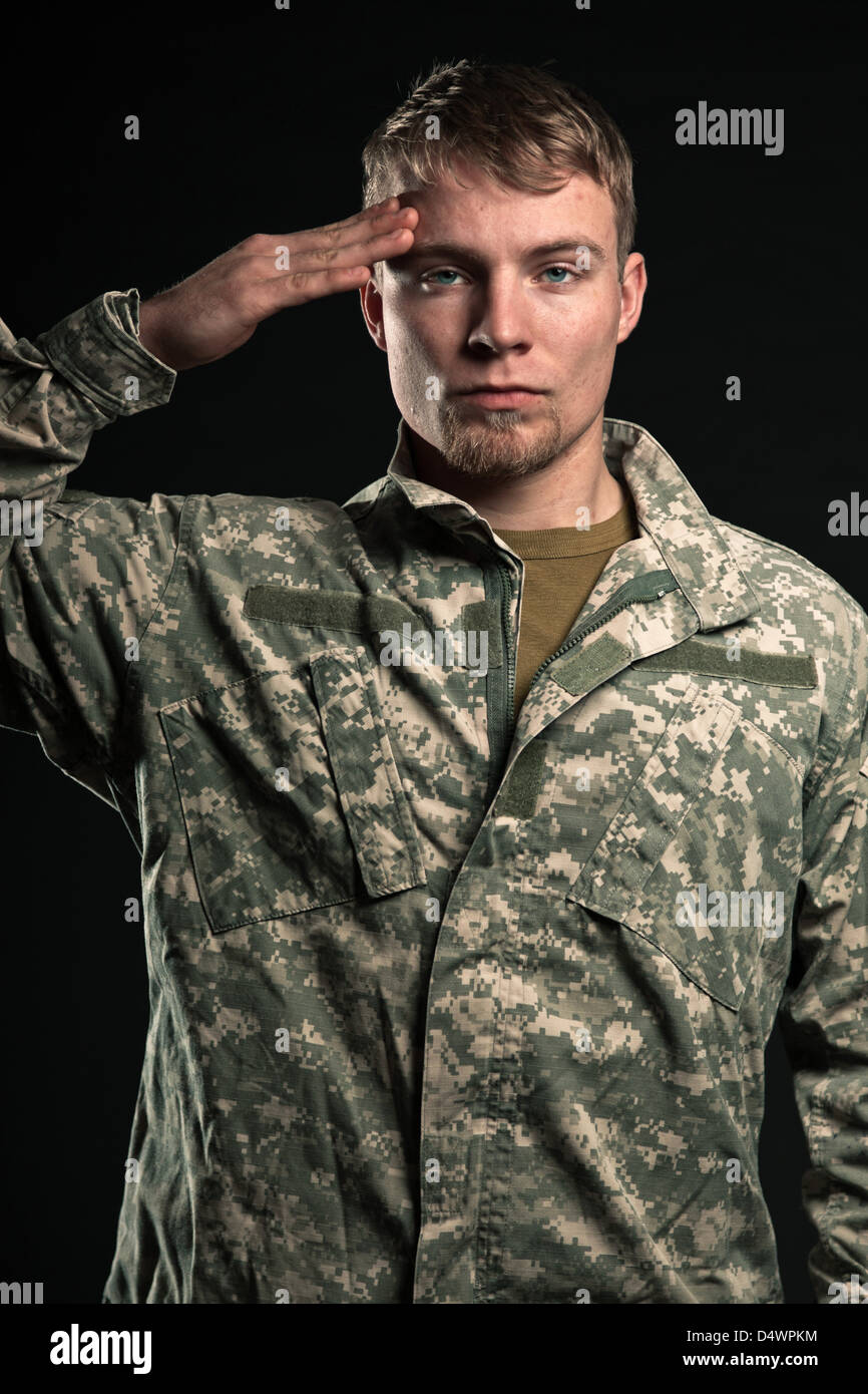 Military young man salutes. Studio portrait Stock Photo - Alamy