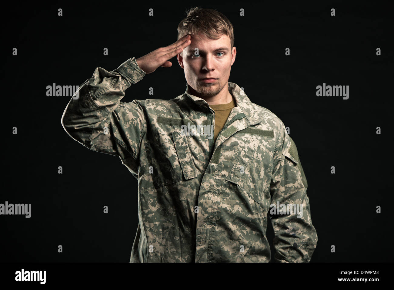 Military young man salutes. Studio portrait Stock Photo - Alamy