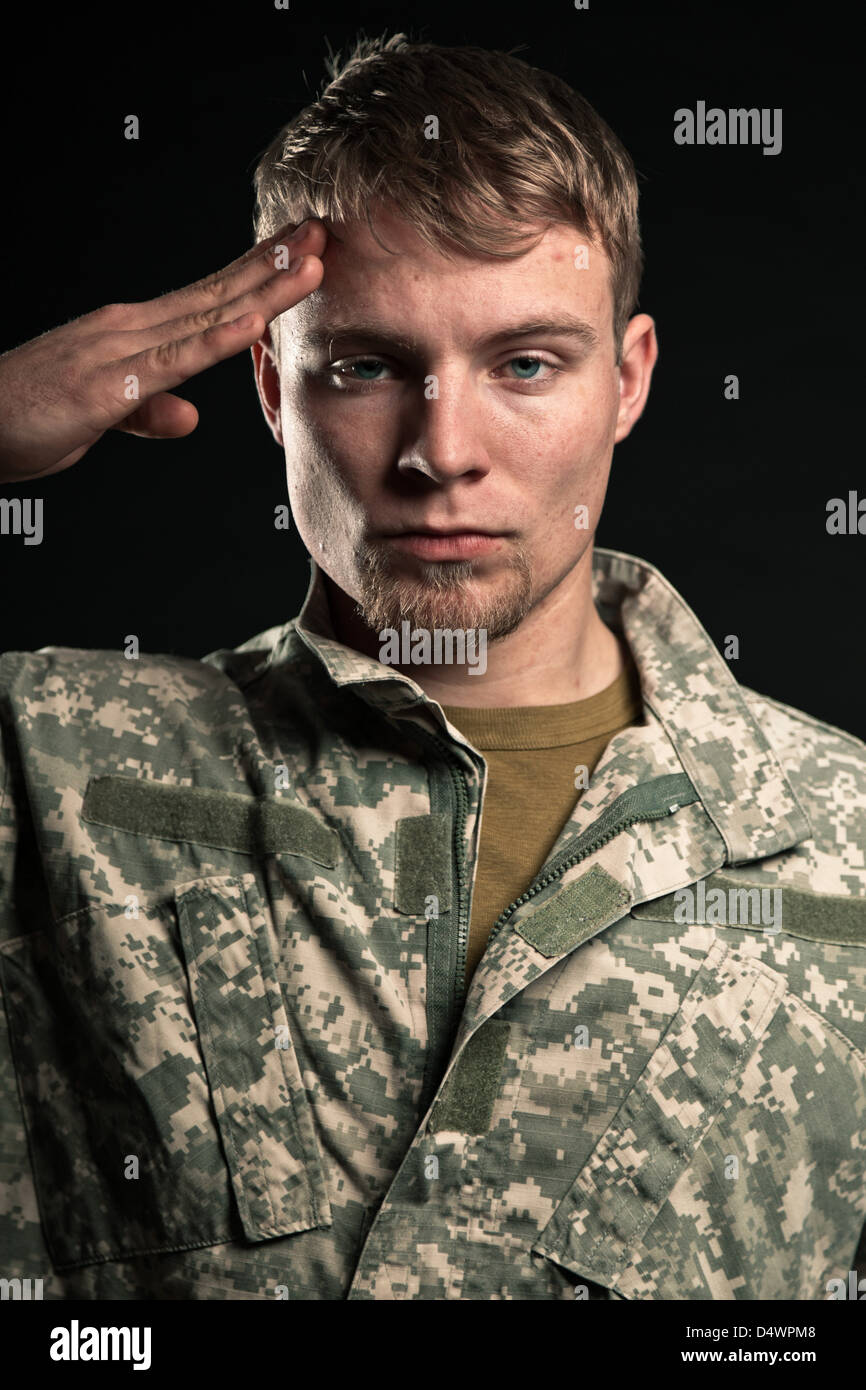 Military young man salutes. Studio portrait Stock Photo - Alamy