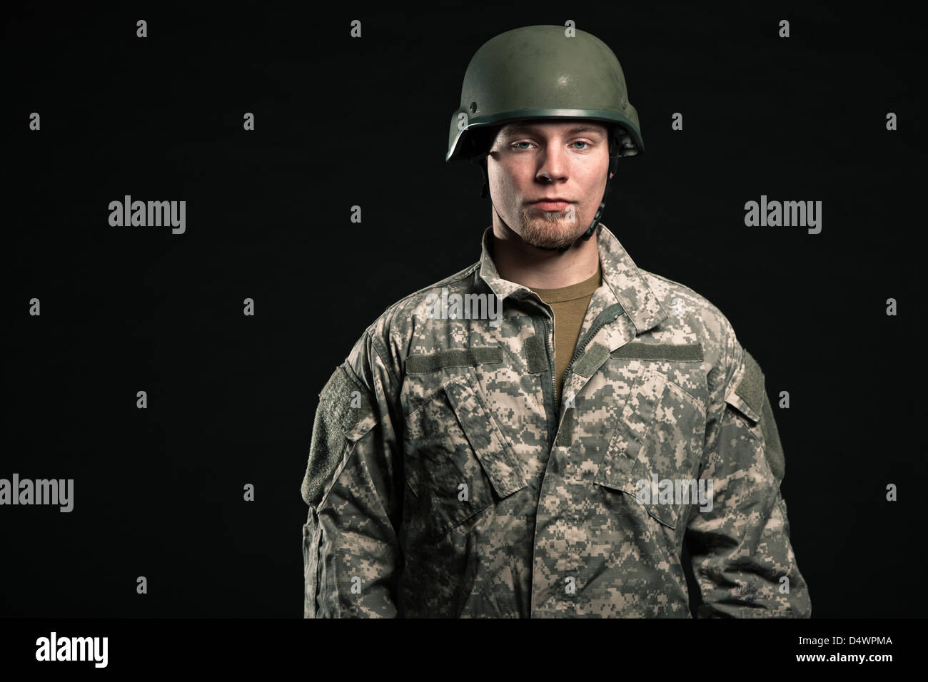 Military young man wearing helmet. Studio portrait Stock Photo - Alamy