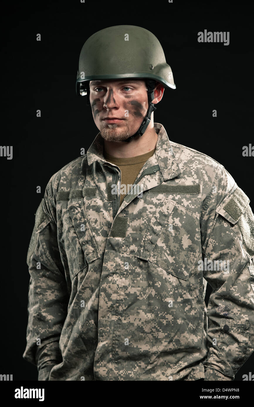 Military young man wearing helmet. Studio portrait Stock Photo - Alamy