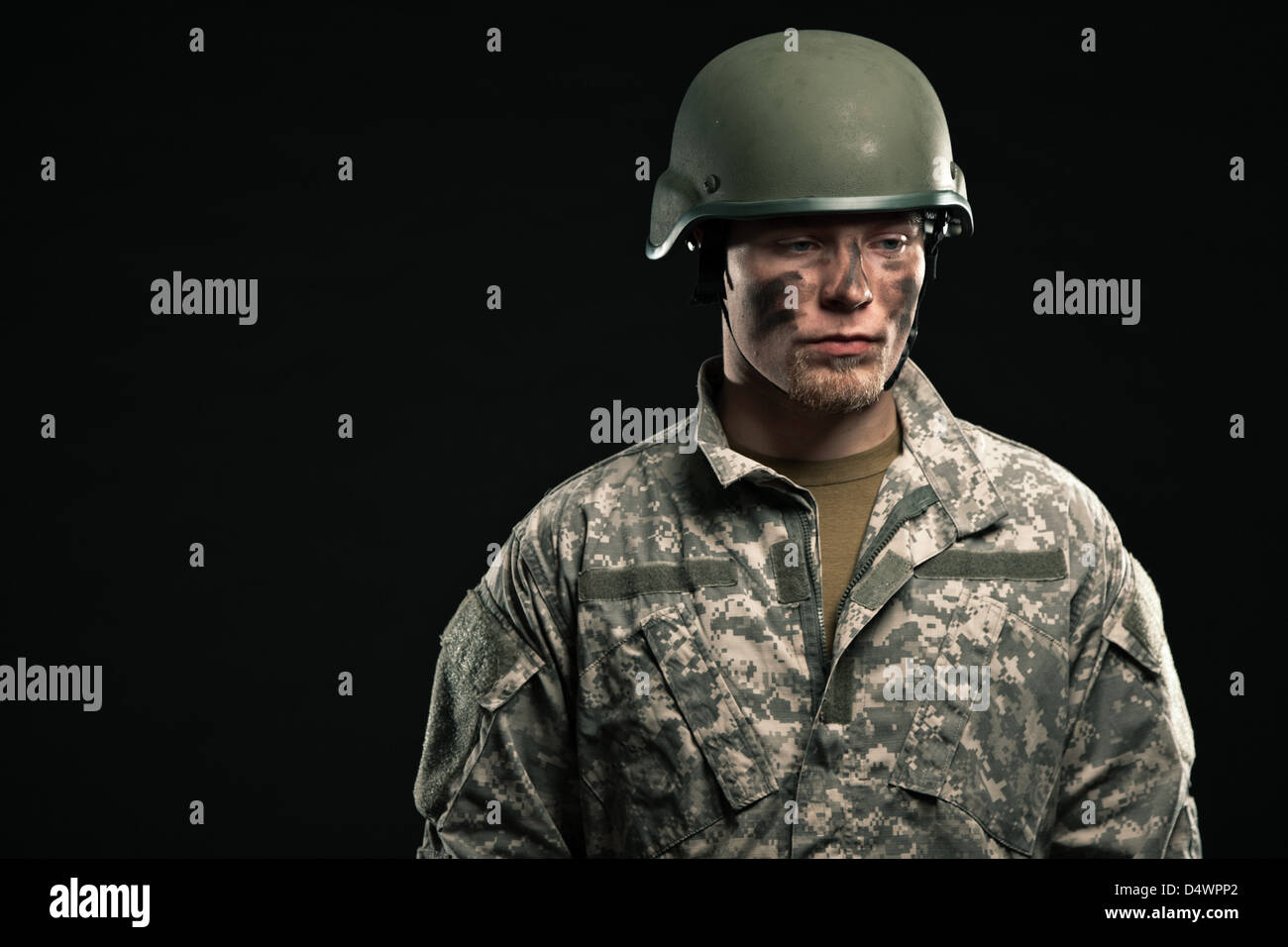 Military young man wearing helmet. Studio portrait Stock Photo - Alamy