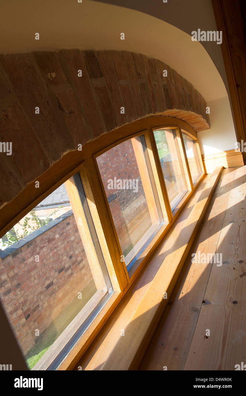 Arched double glazed window in a newly converted barn in the rural ...
