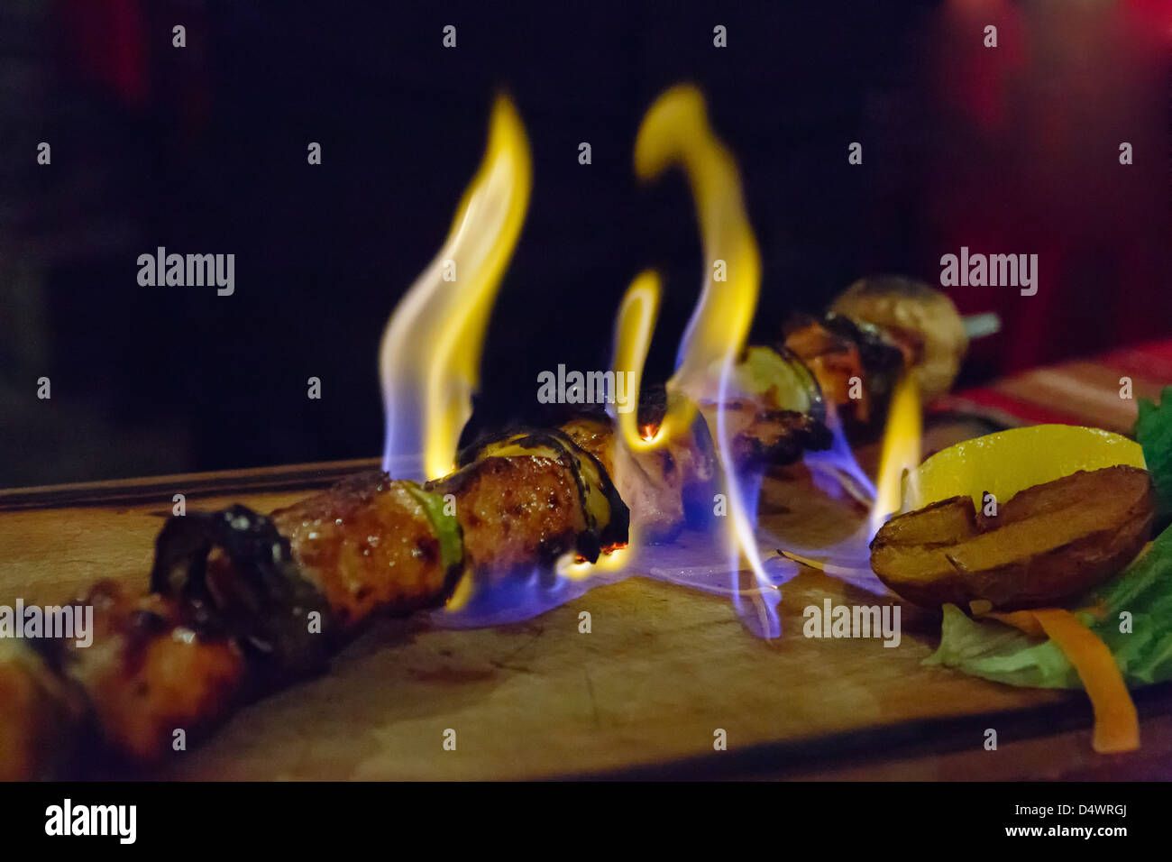 Flambe of a chicken shish kebab with vegetables Stock Photo - Alamy