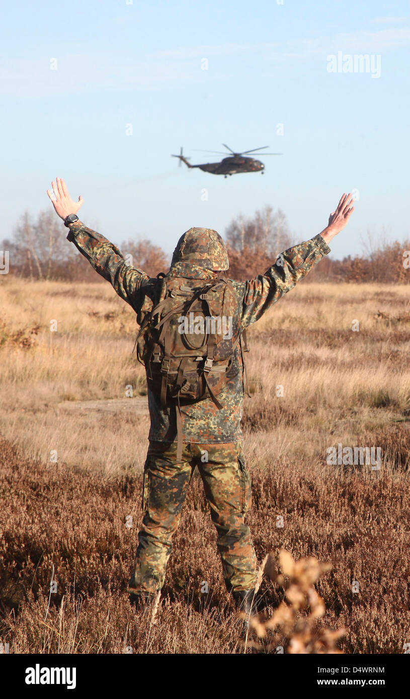 A German Army soldier guides a CH-53GS to the landing zone at the ...
