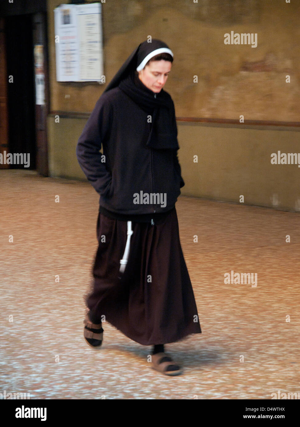 A young nun walks quickly in Bologna Stock Photo - Alamy