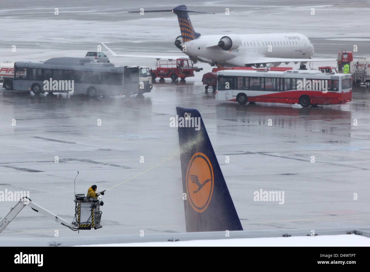A Lufthansa aircraft is de-iced at Hamburg Airport in Hamburg, Germany ...
