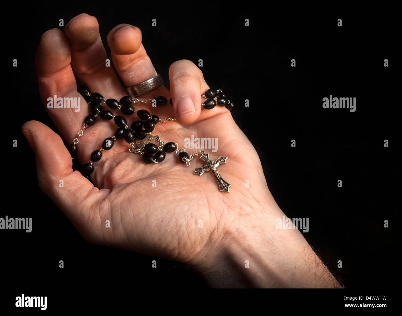 Praying Hands Holding Rosary Beads High Resolution Stock Photography ...