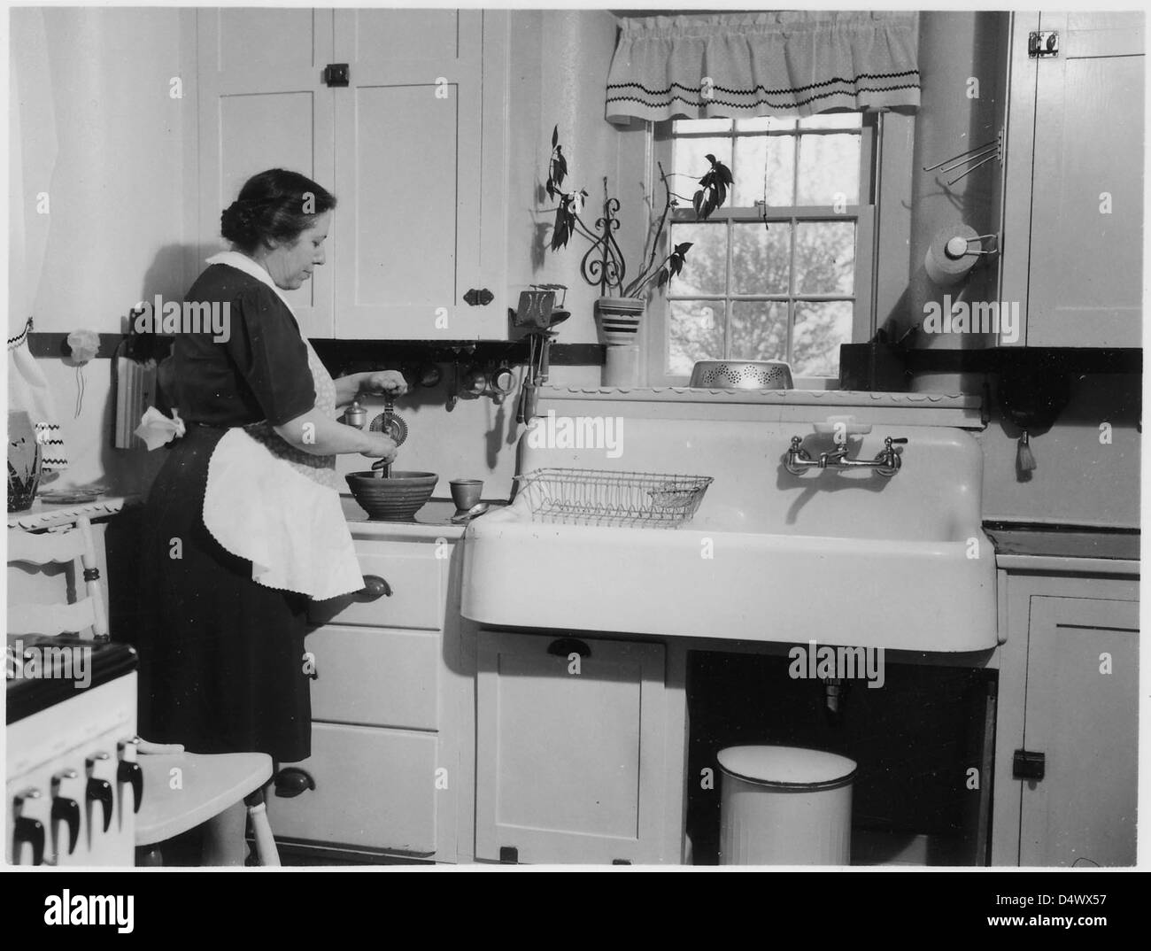 A woman is shown cooking in a kitchen, highlighting the role of women ...