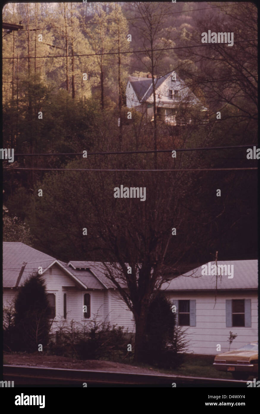 A view showing miners' homes positioned along railroad tracks with the ...