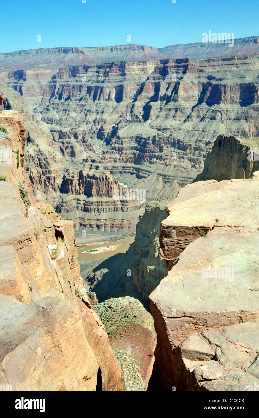 A crevice in rocks at the edge of the Grand Canyon is hundreds of feet ...