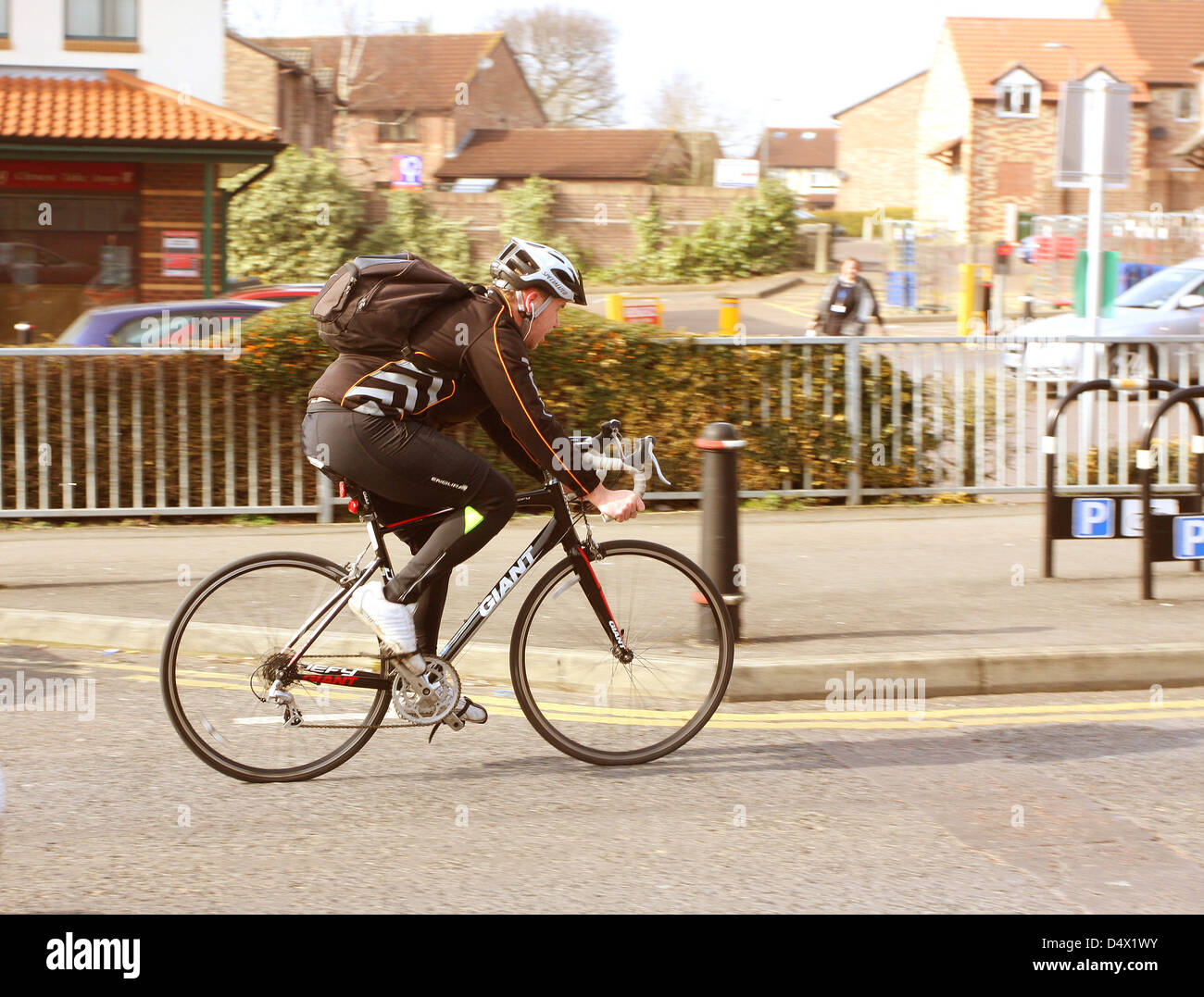 male touring cyclist on his road bike on the street Stock Photo - Alamy