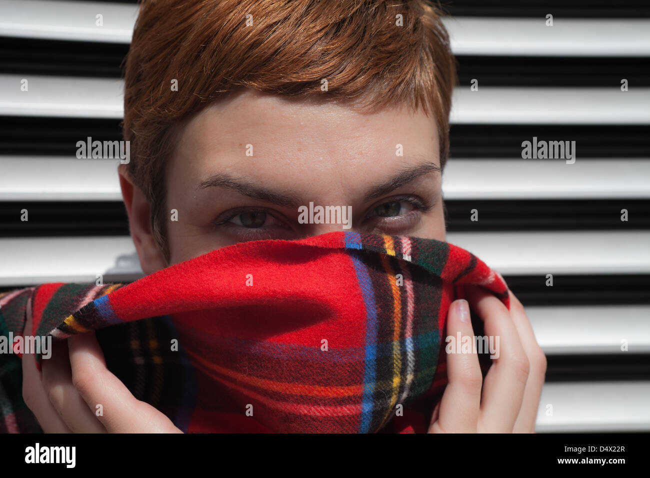 young woman covering her face with red scarf Stock Photo - Alamy