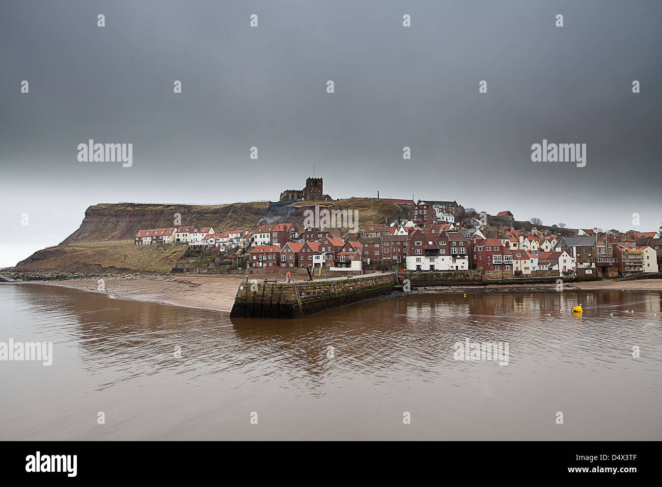 Whitby East Cliff on the North York Moors coast line on a very overcast ...