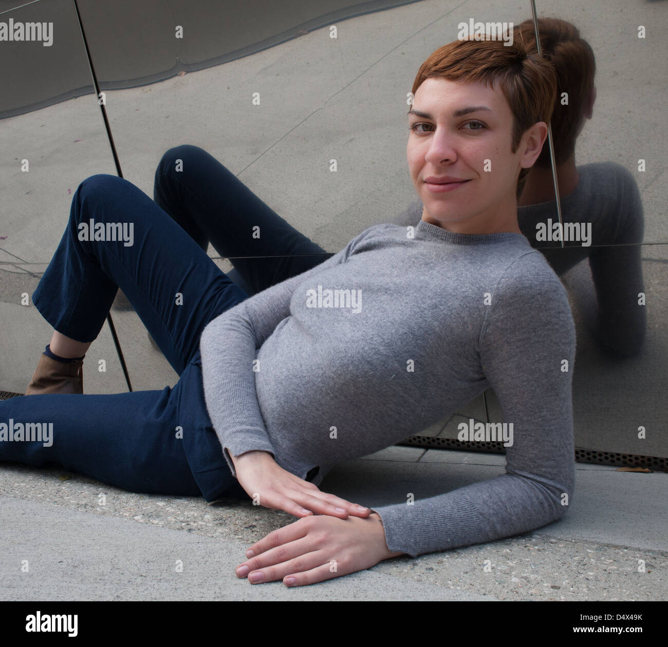 female model in front of reflective background,smiling, full body shot ...