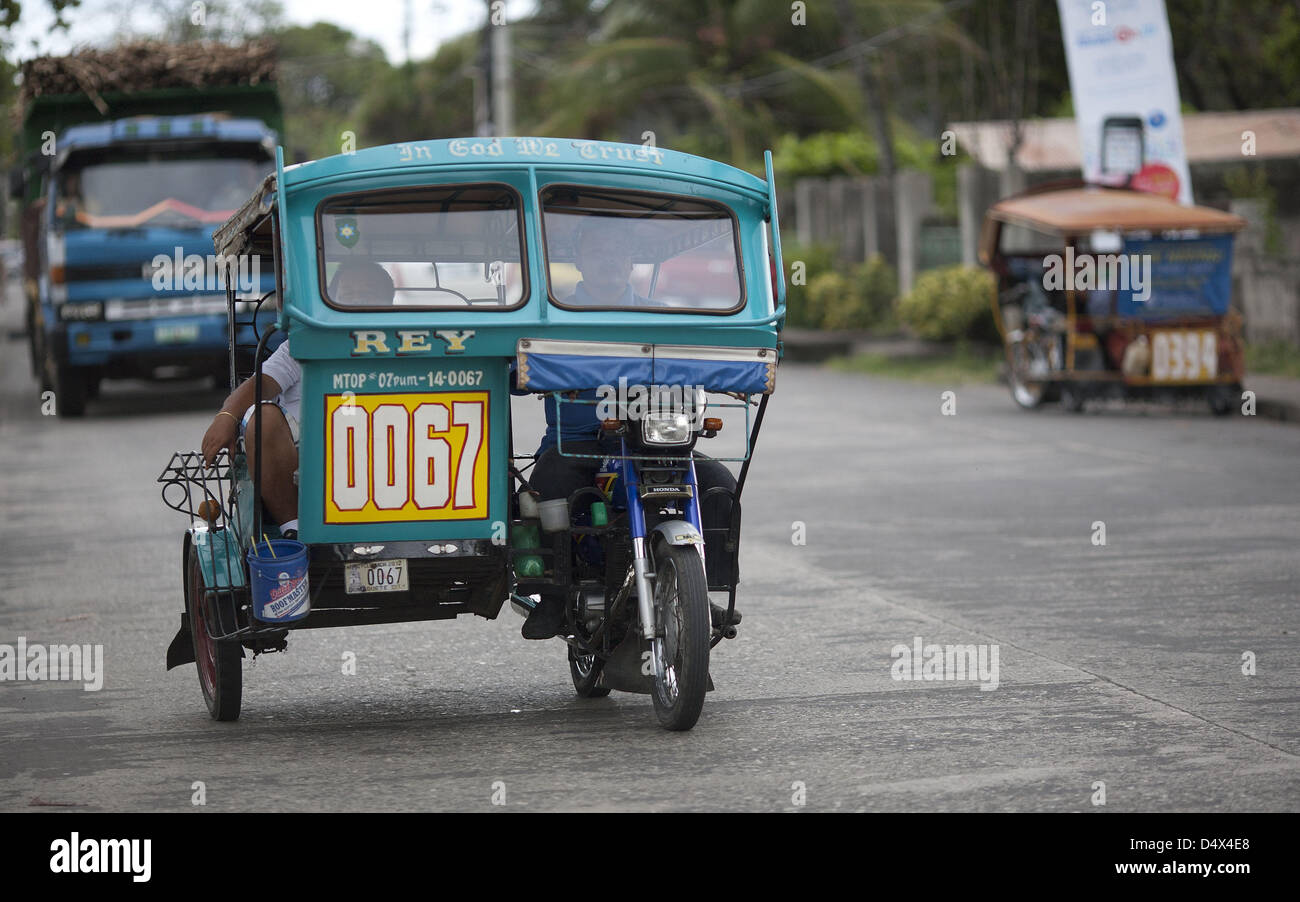 March 12, 2013 - Dumaguete, PHILLIPPINES, PHI - A pedicab drives on the ...