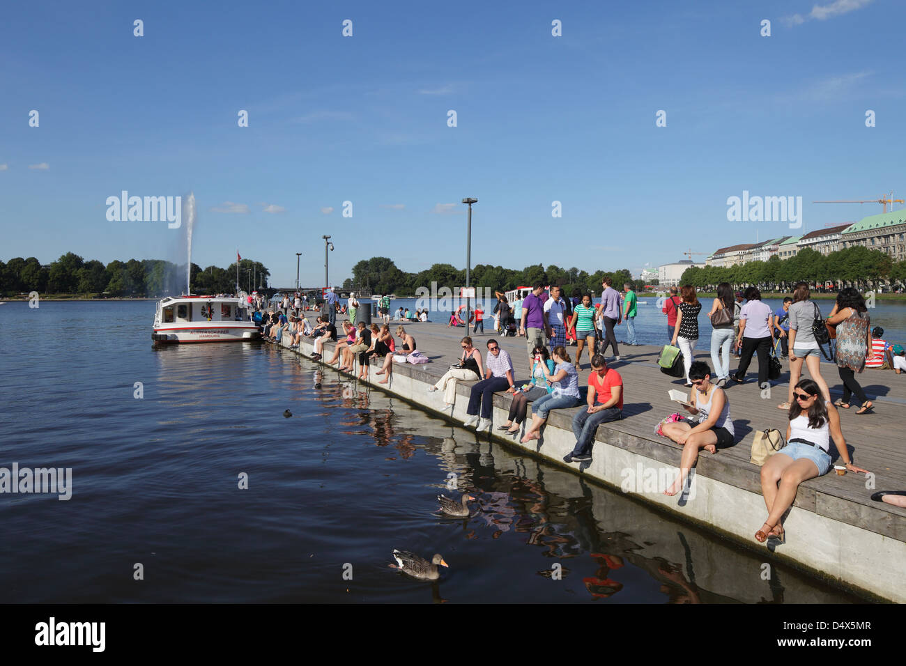 Hamburg, Germany, people are sitting on a jetty on the Inner Alster ...