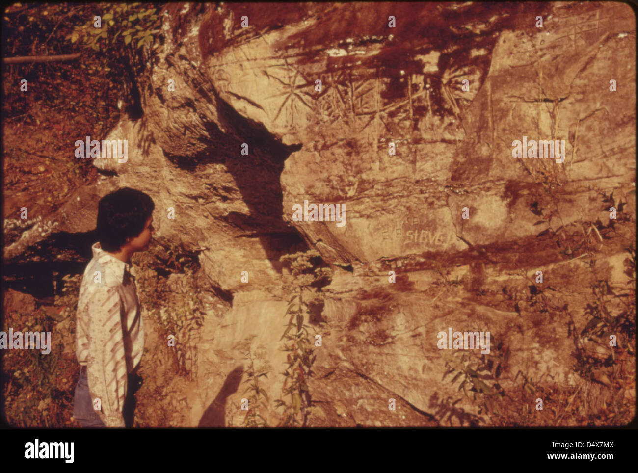 Ron McKinney, a 22-year-old Potawatomie-Kickapoo, observes petroglyphs ...