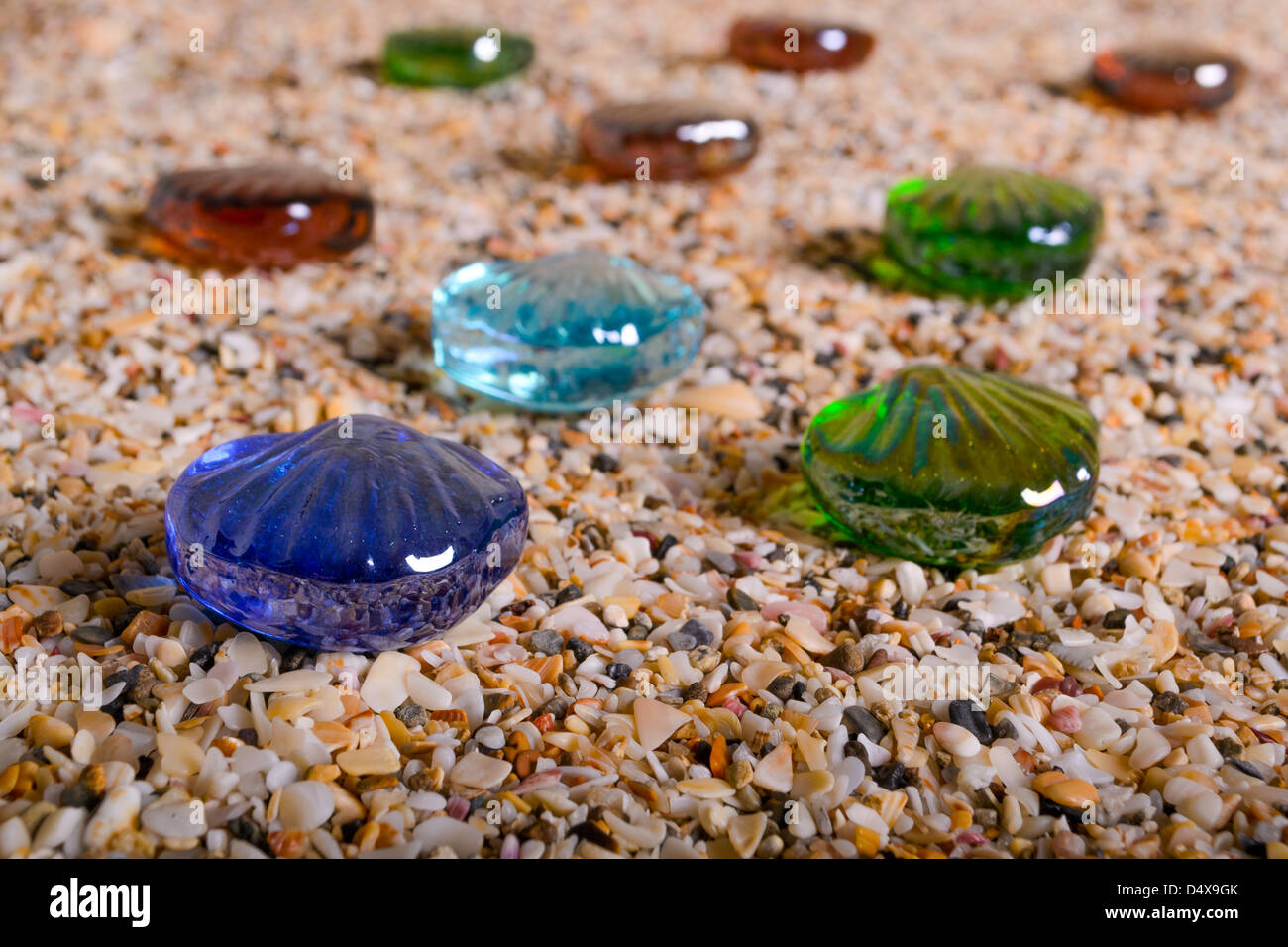 glass sea shells with sand as background Stock Photo - Alamy