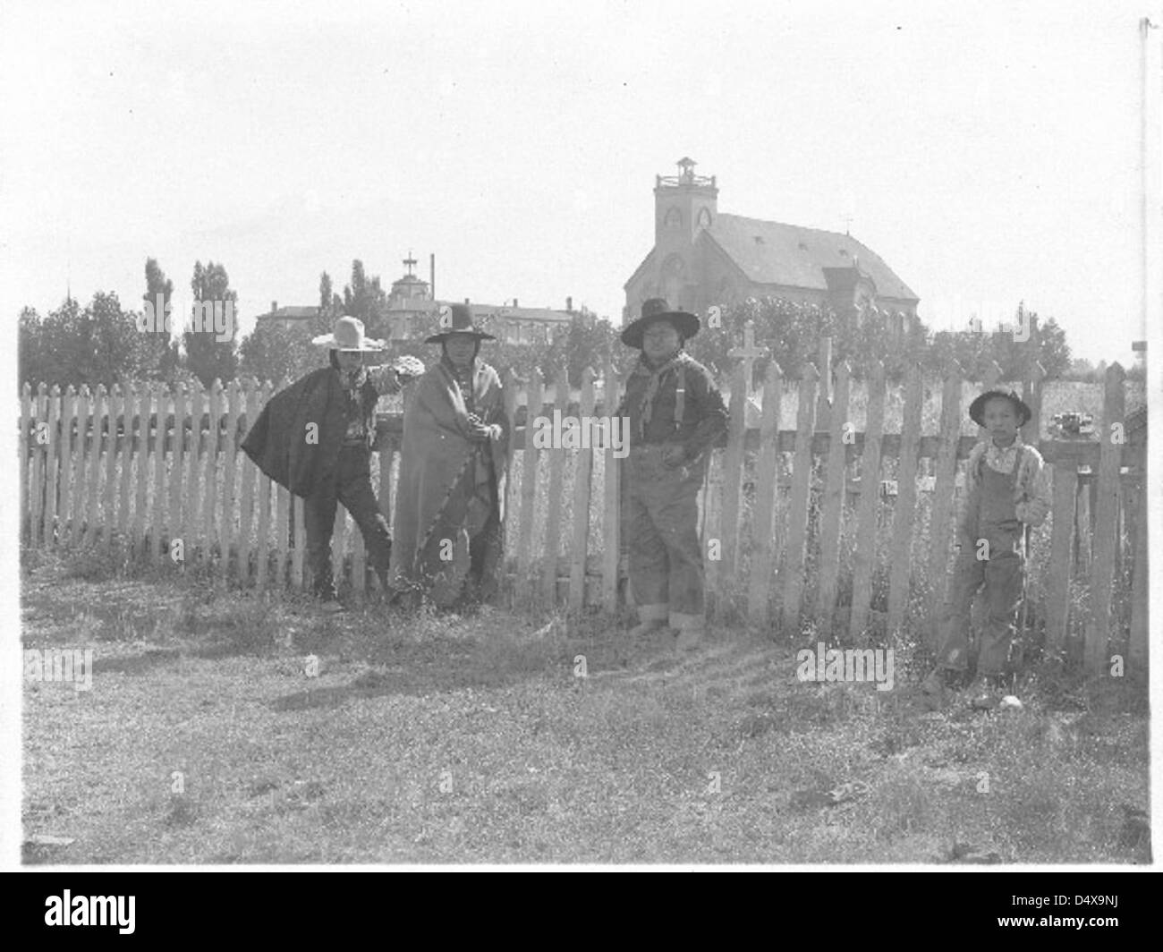 A photo showing three Native American men and one boy standing in front ...