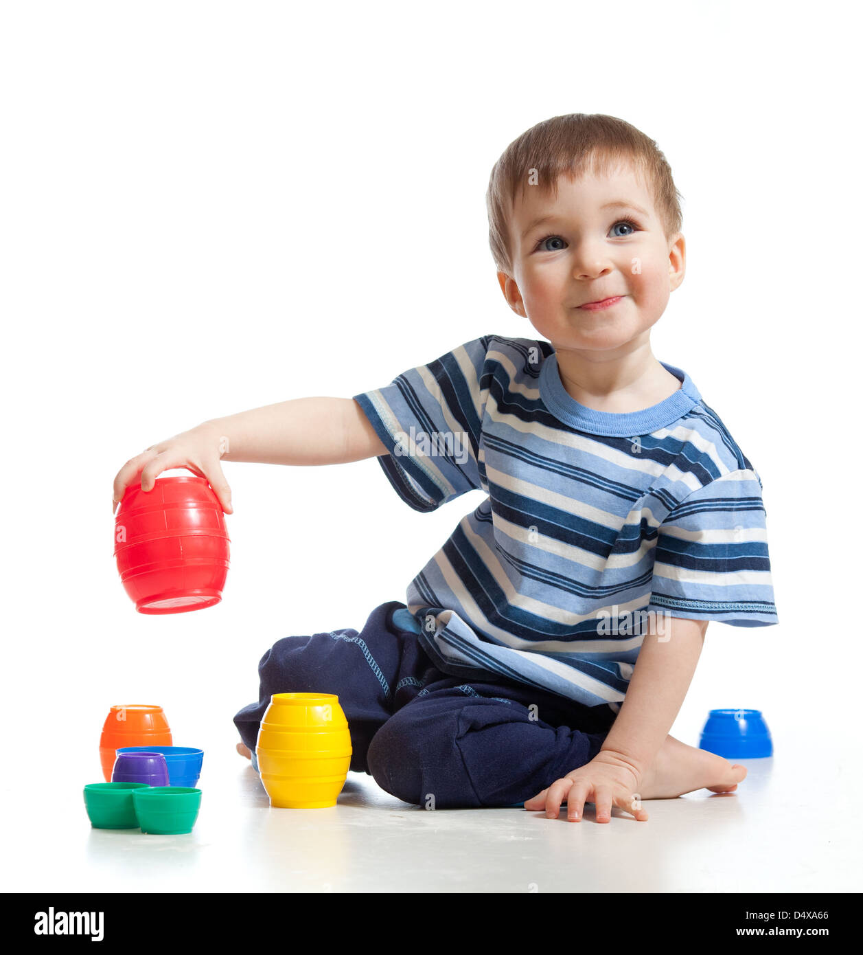 Cute little child is playing with toys while sitting on floor, isolated ...
