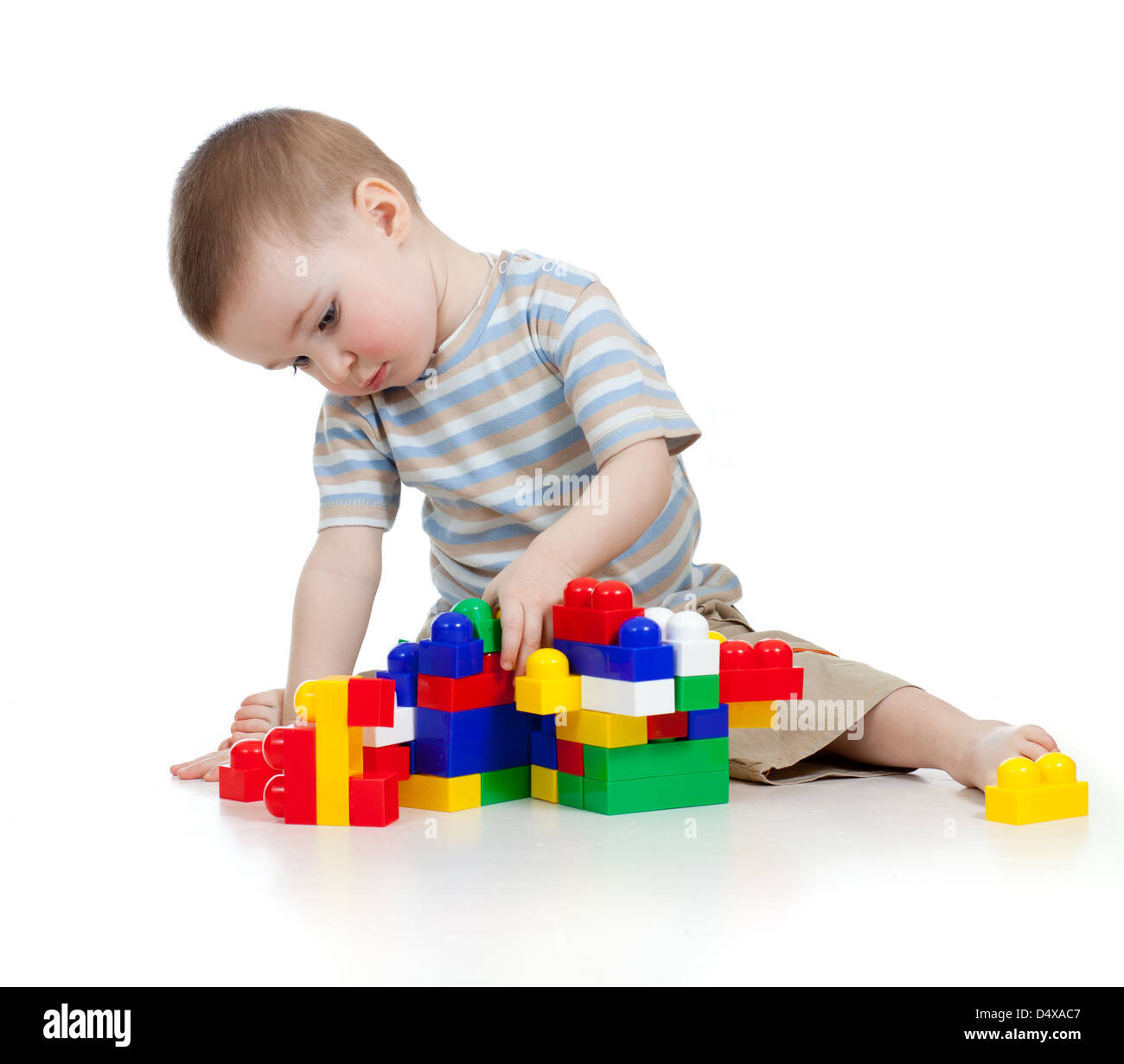 little cheerful child with construction set over white background Stock ...