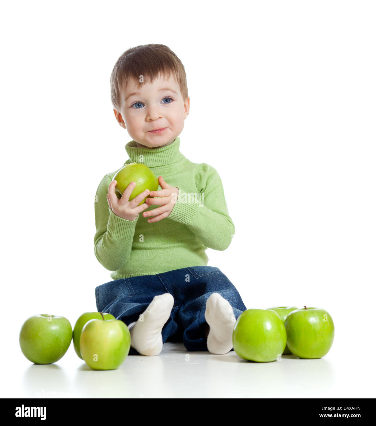 Adorable child with green apples Stock Photo - Alamy