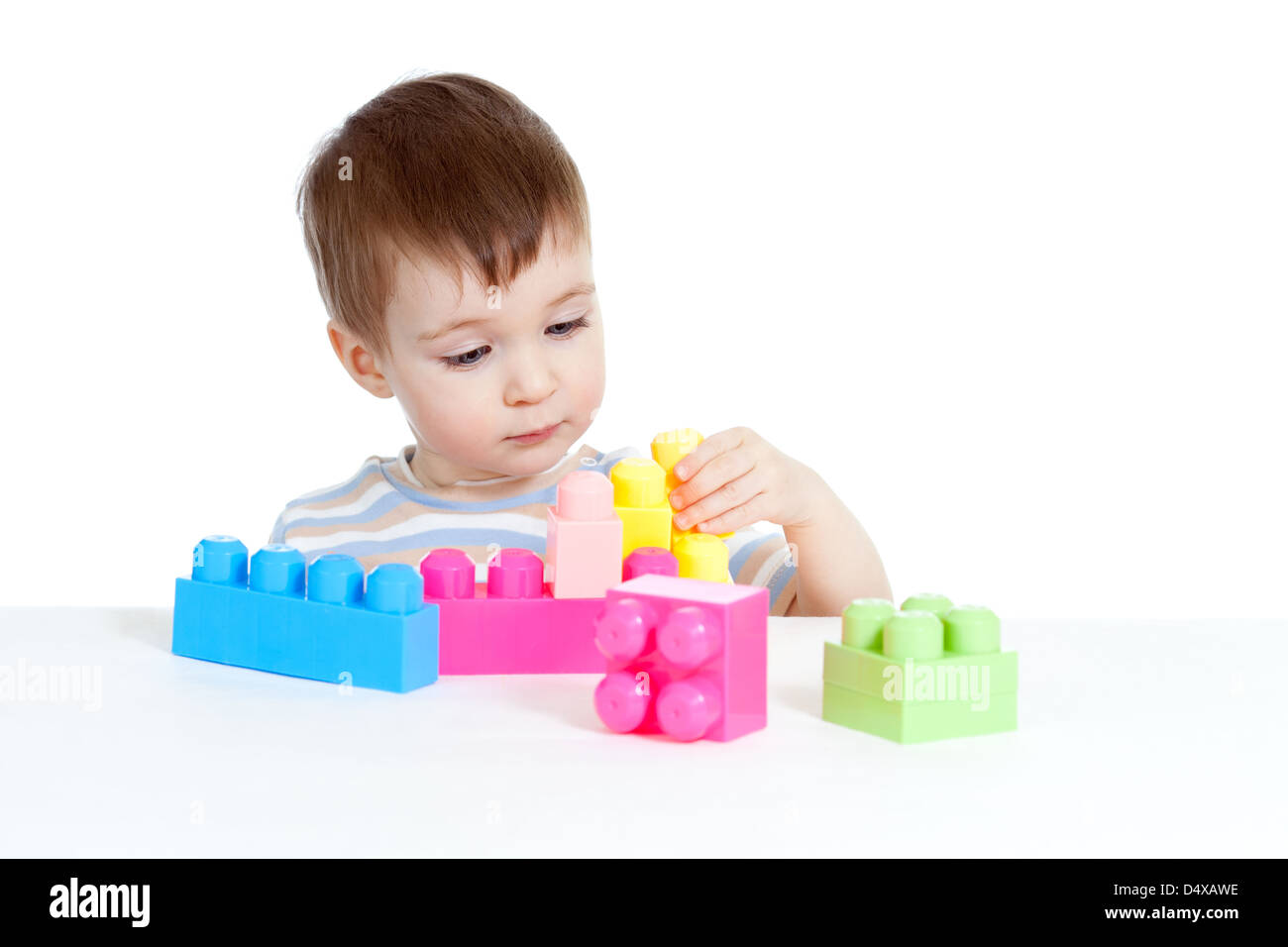 little cheerful child with construction set over white background Stock ...