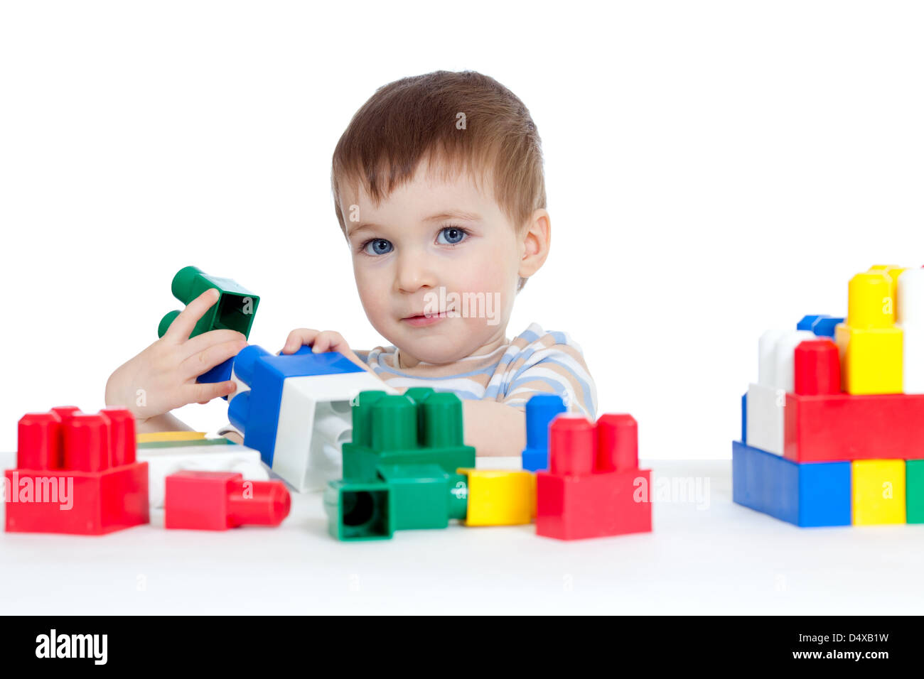 little cheerful child with construction set over white background Stock ...