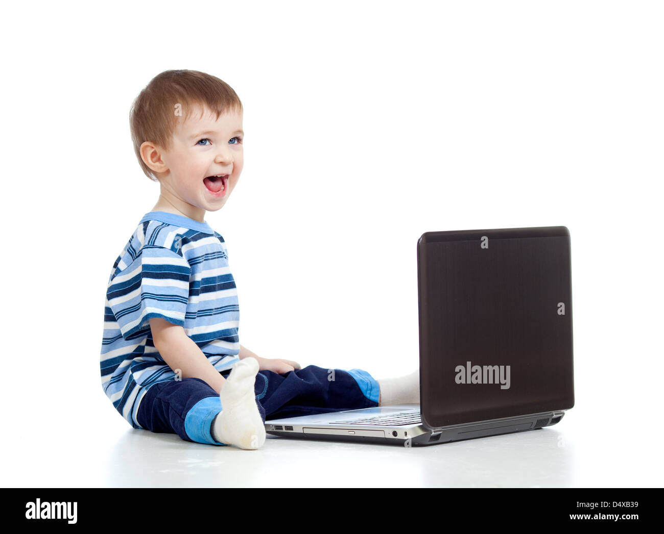 Funny child using a laptop over white background Stock Photo - Alamy