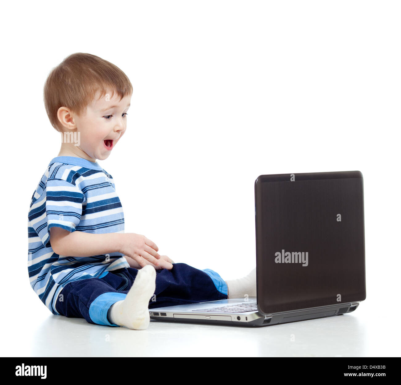 Funny child using a laptop over white background Stock Photo - Alamy