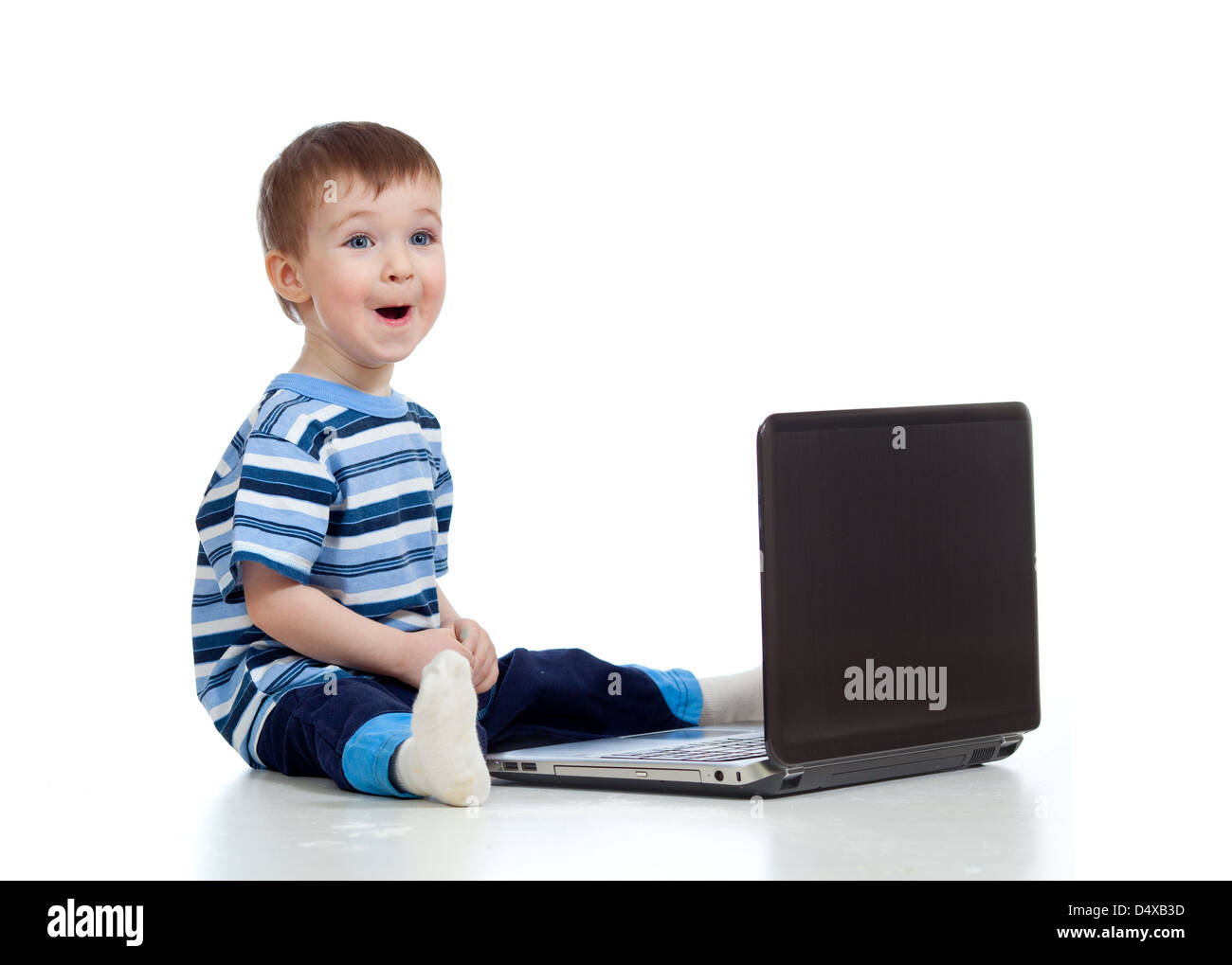 Cheerful child boy using a laptop over white background Stock Photo - Alamy