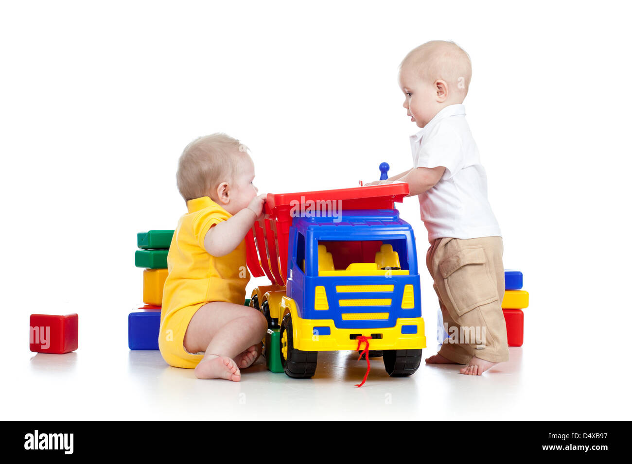 two little children playing together with color toys Stock Photo - Alamy
