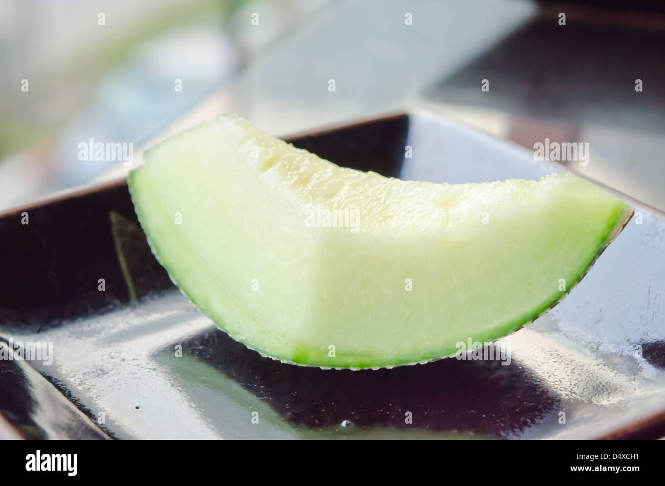 single cantaloupe melon slices on plate Stock Photo - Alamy