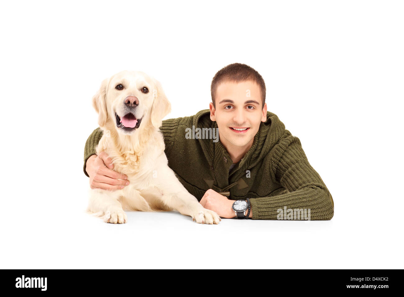 A young smiling man next to his best friend labrador dog isolated on ...
