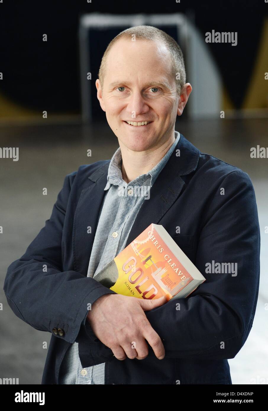 British writer and journalist Chris Cleave poses with his book 'Gold ...