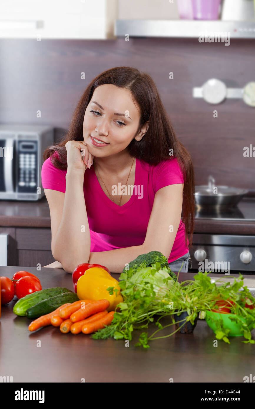 Young woman making salad at domestic kitchen Stock Photo - Alamy