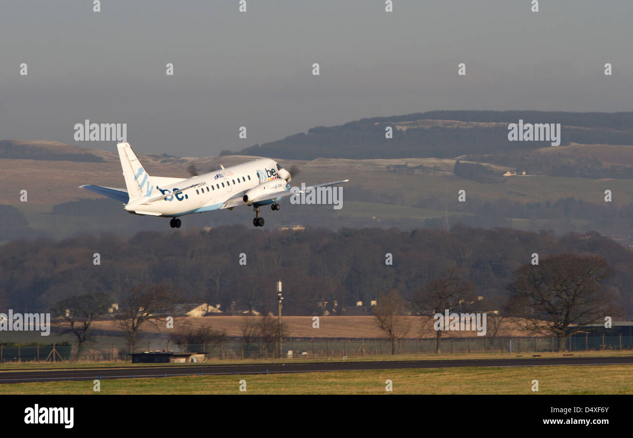 Flybe Saab 340 twin prop airplane takes of from Glasgow airport Stock ...