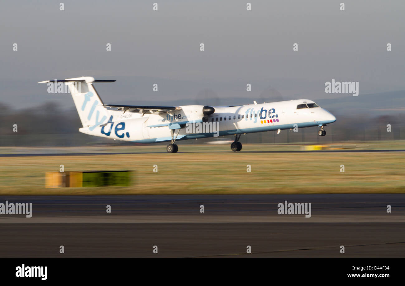 Flybe Saab 340 twin prop airplane takes of from Glasgow airport Stock ...