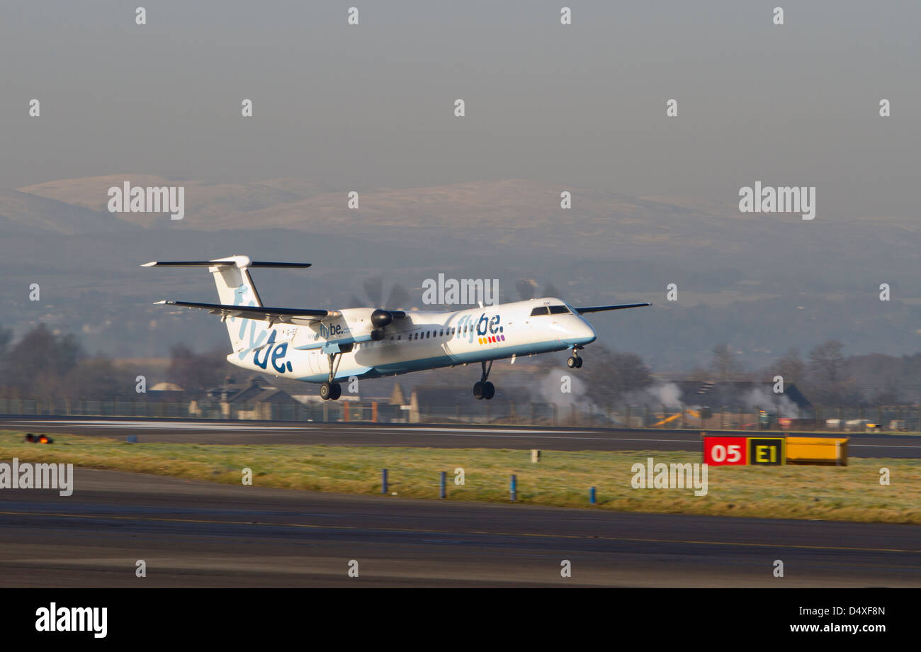 Flybe Saab 340 twin prop airplane takes of from Glasgow airport Stock ...