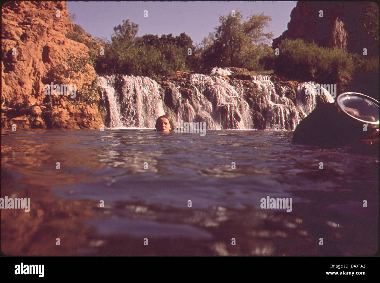 This photograph shows a bather cooling off in the natural pool of ...