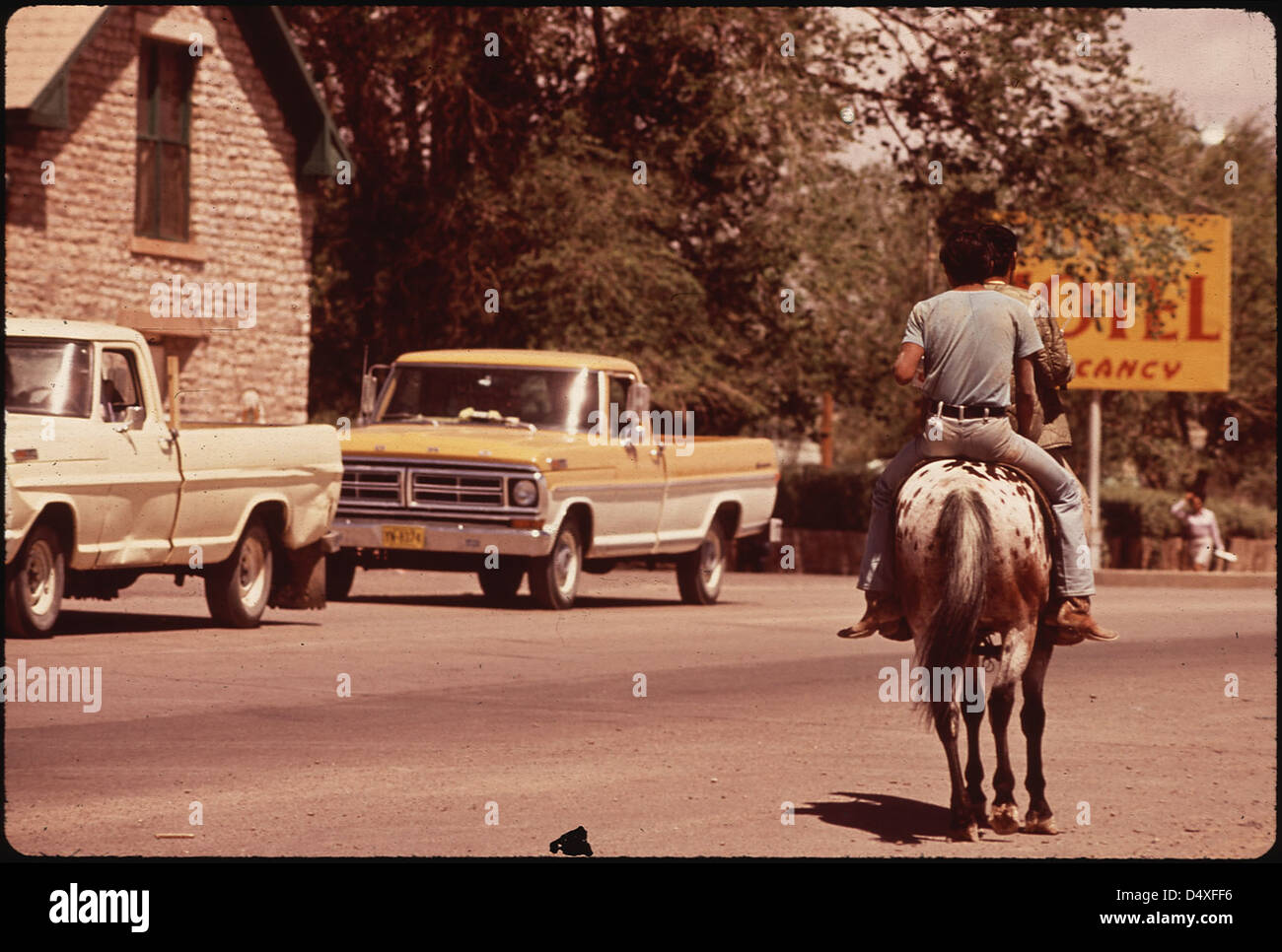 A photograph showing a Native American rider on horseback alongside ...