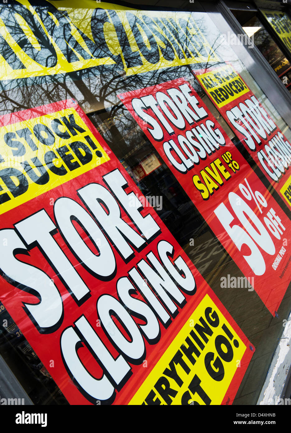 Store Closing Signs On A Shop Window Oxfordshire England Stock Photo store-closing-signs-on-a-shop-window-oxfordshire-england-stock-photo