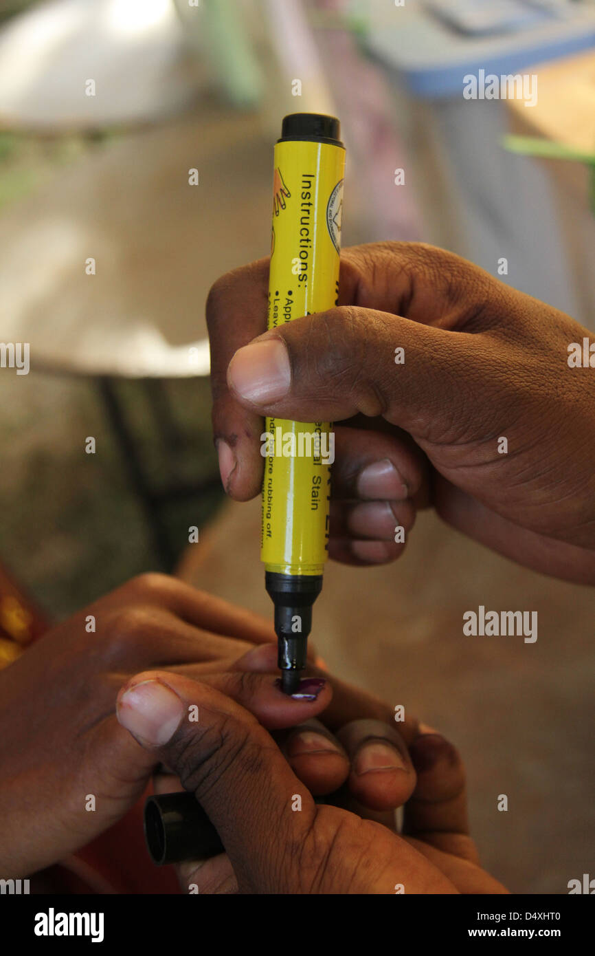 A voter gets her finger marked with a permanent marker pen after the ...