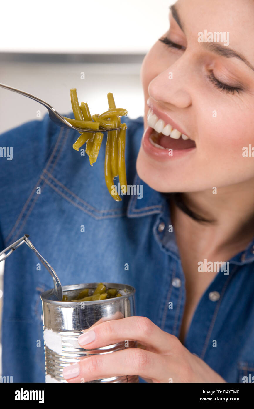 Woman eating green beans Stock Photo - Alamy